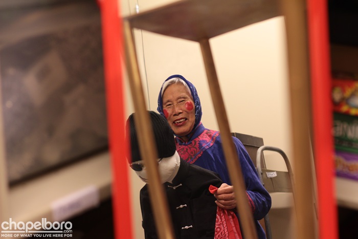 Guang Jun Zeng checks in the mirror before going on stage - Chapelboro.com